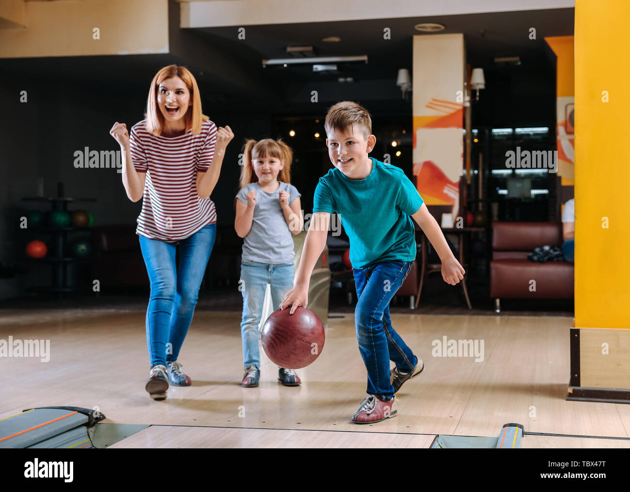Family playing bowling in club Stock Photo - Alamy