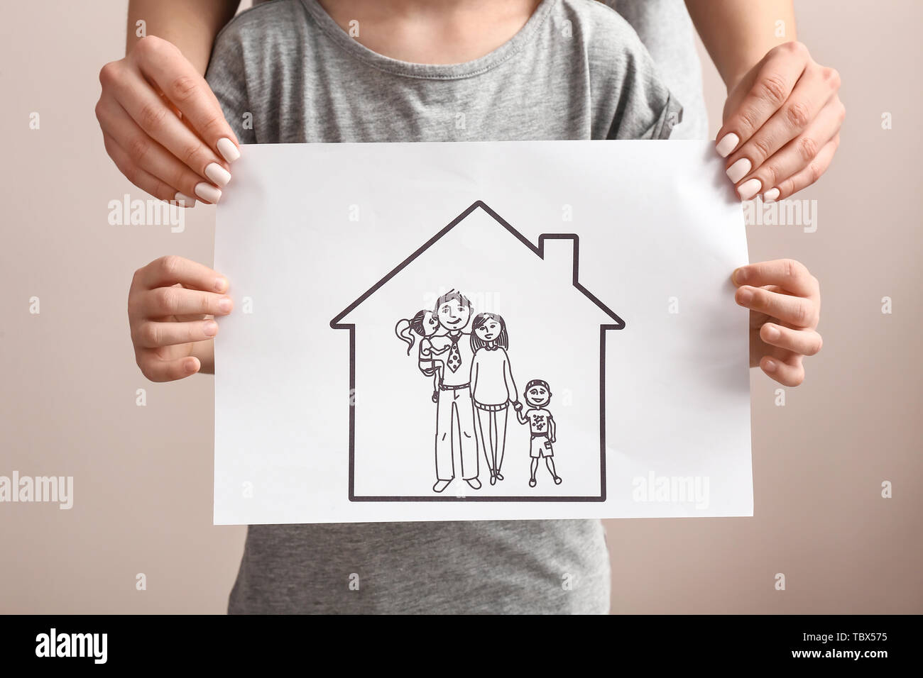 Woman and child with drawing of family. Concept of adoption Stock Photo ...