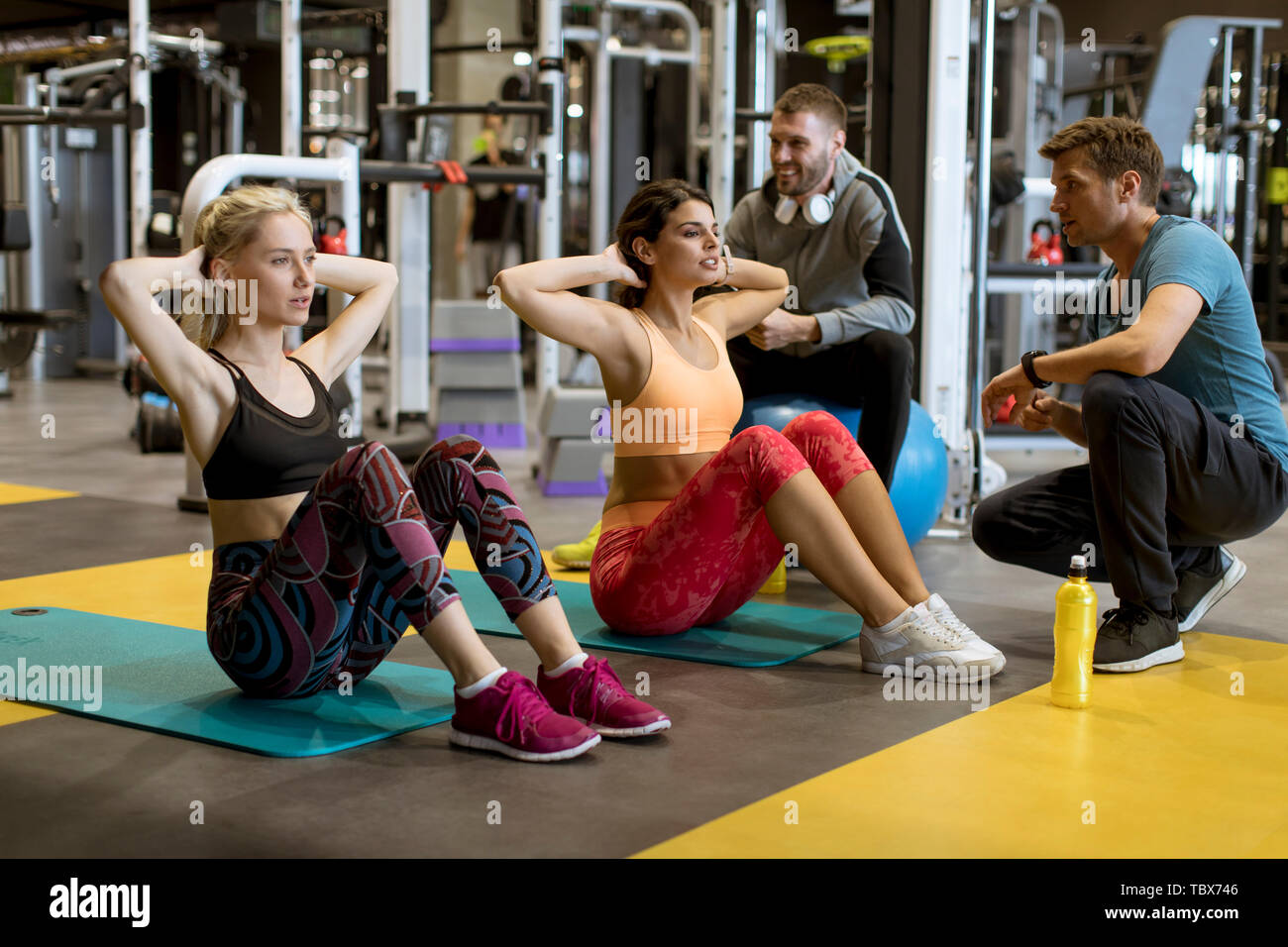 Handsome fit people doing crunches at gym Stock Photo - Alamy