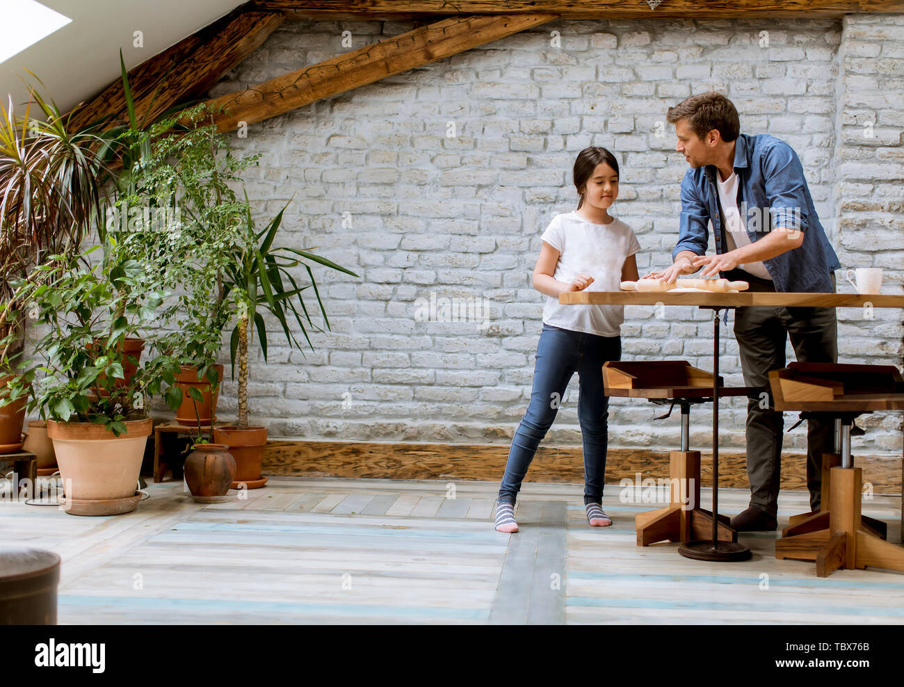 Father and daughter making bread in the rustic kitchen Stock Photo - Alamy