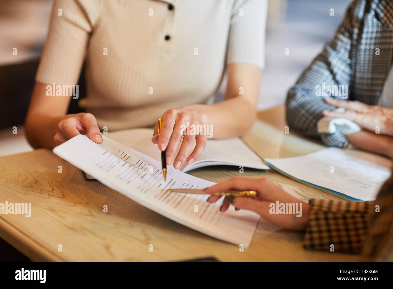 Pointing at business paper Stock Photo - Alamy