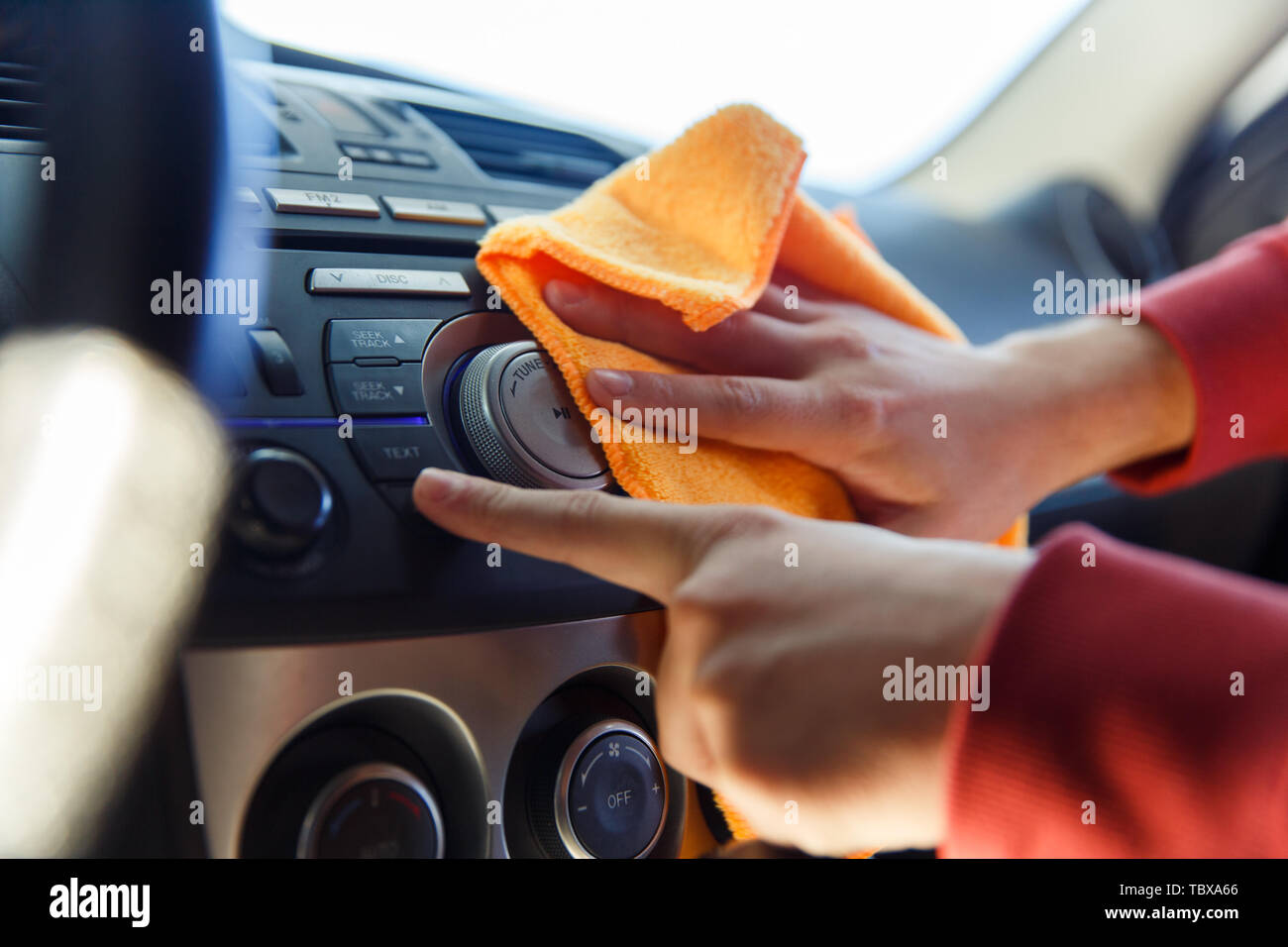 Picture of male's hand with orange rag washing car interior Stock Photo ...