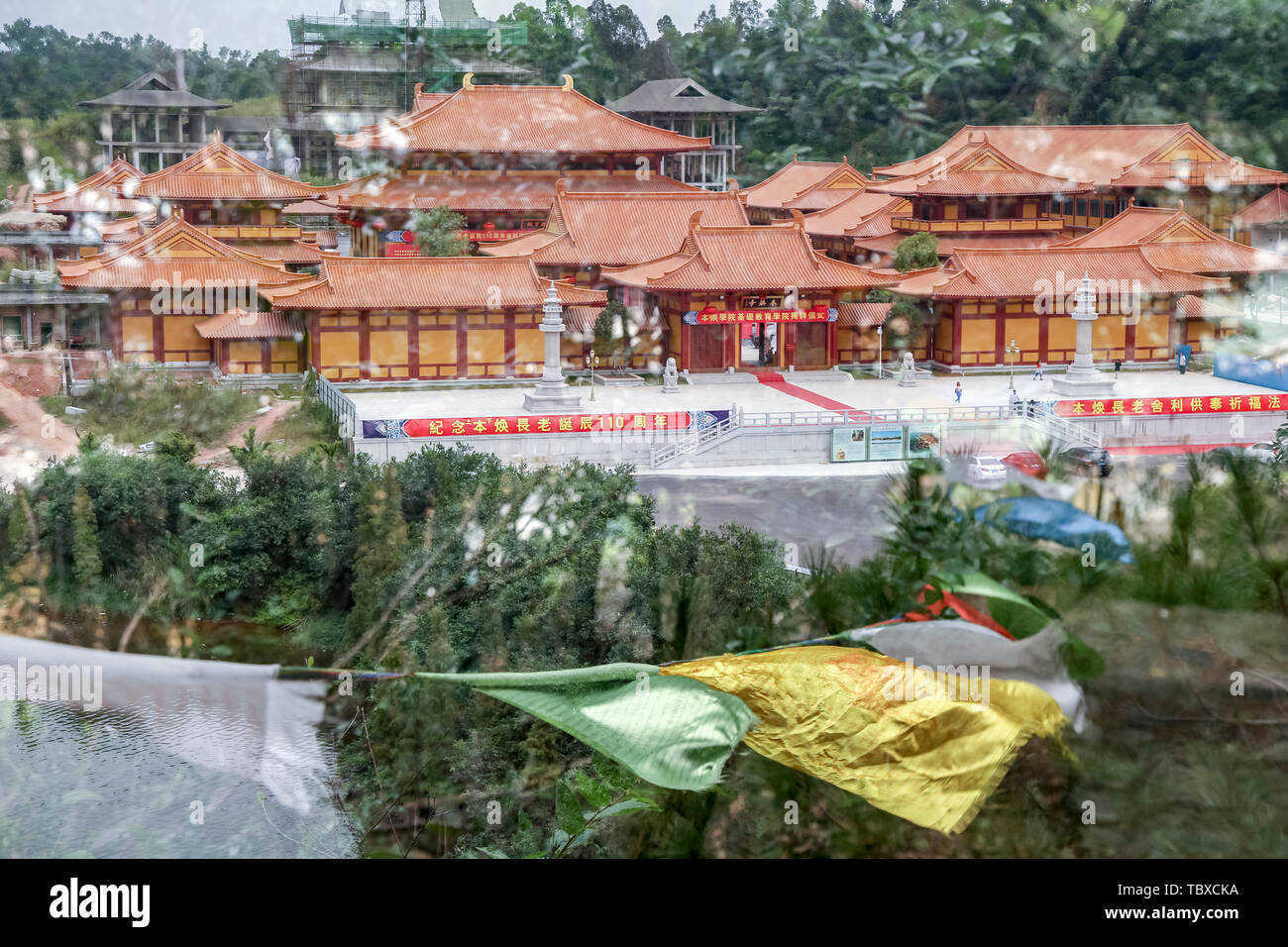 Multiple exposure of Buddhist buildings and prayer flags in Sanshui ...