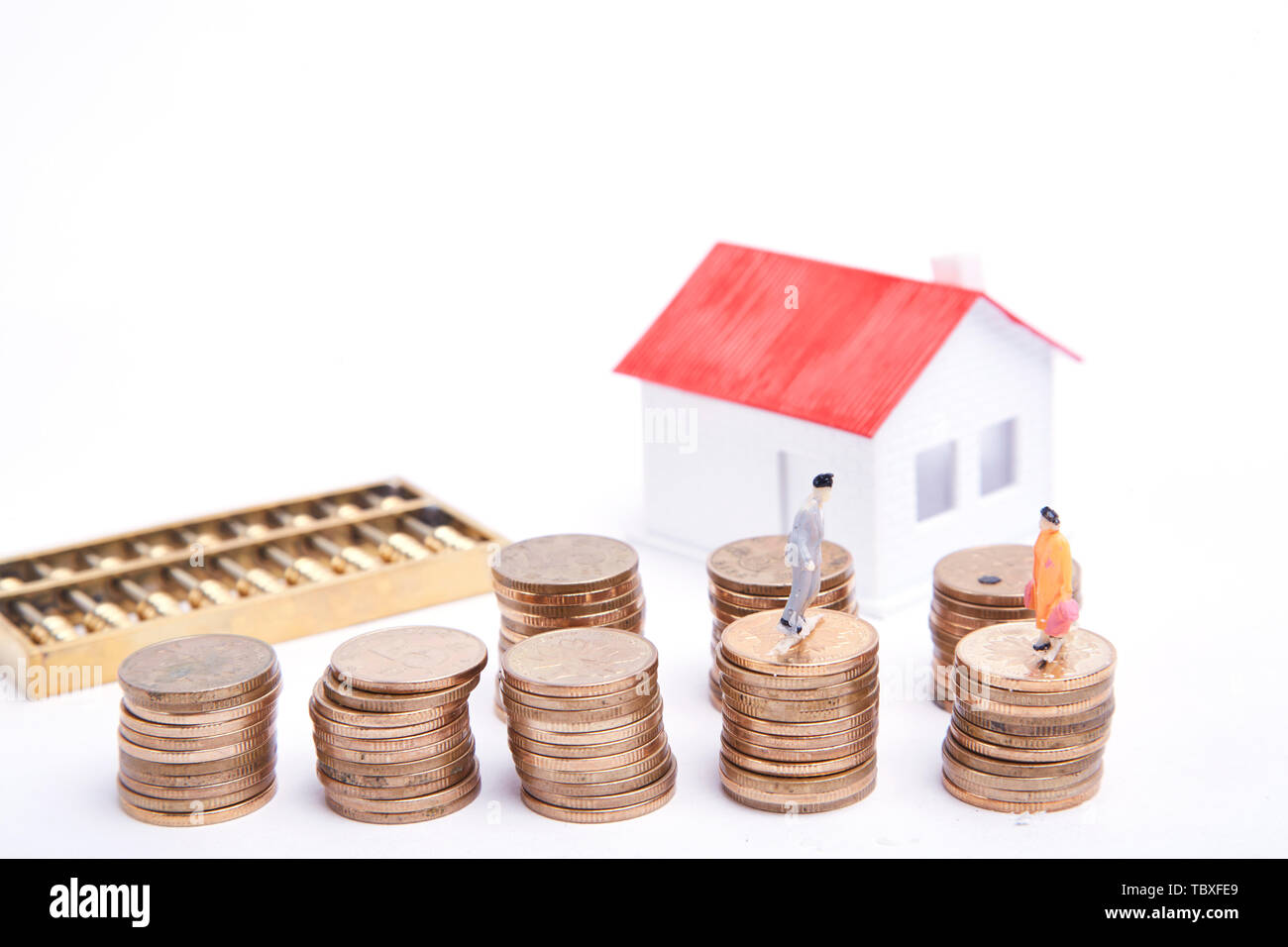 Coin house model and couple on white background Stock Photo - Alamy