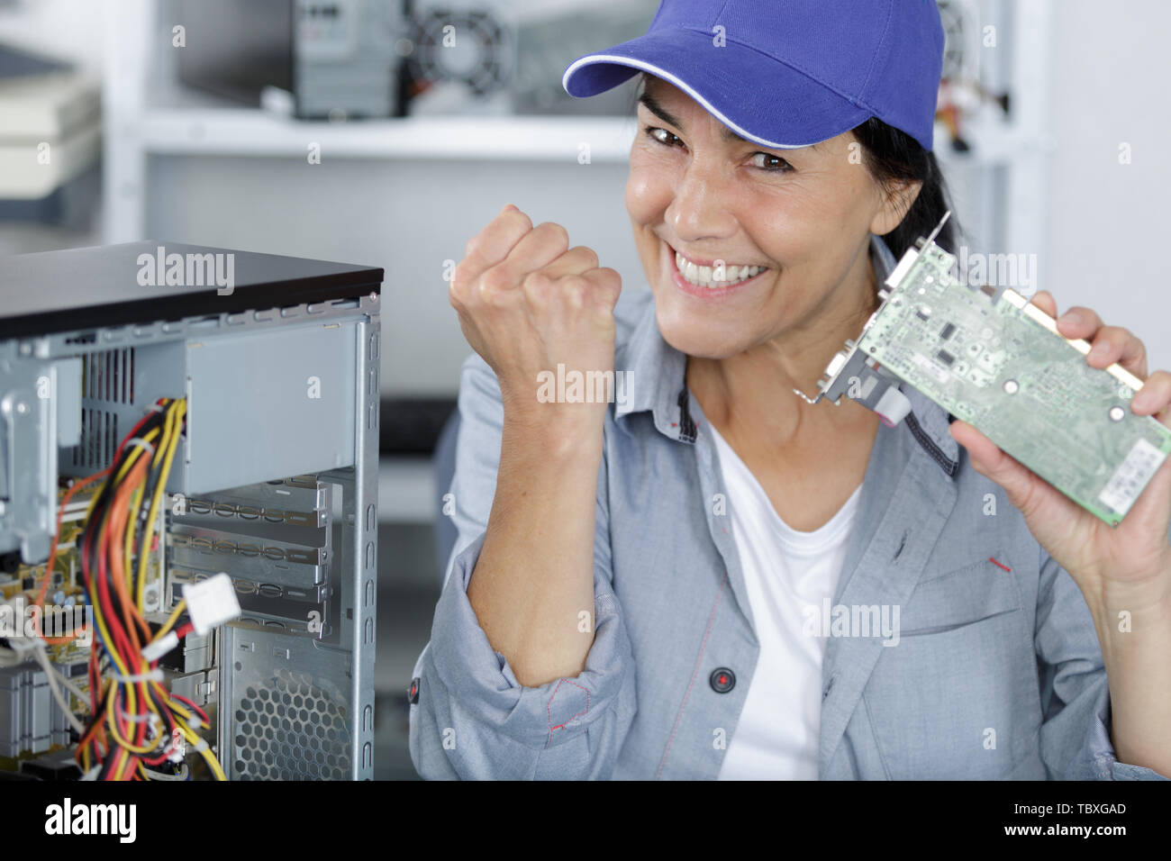 happpy mature female pc technician posing by a computer Stock Photo - Alamy