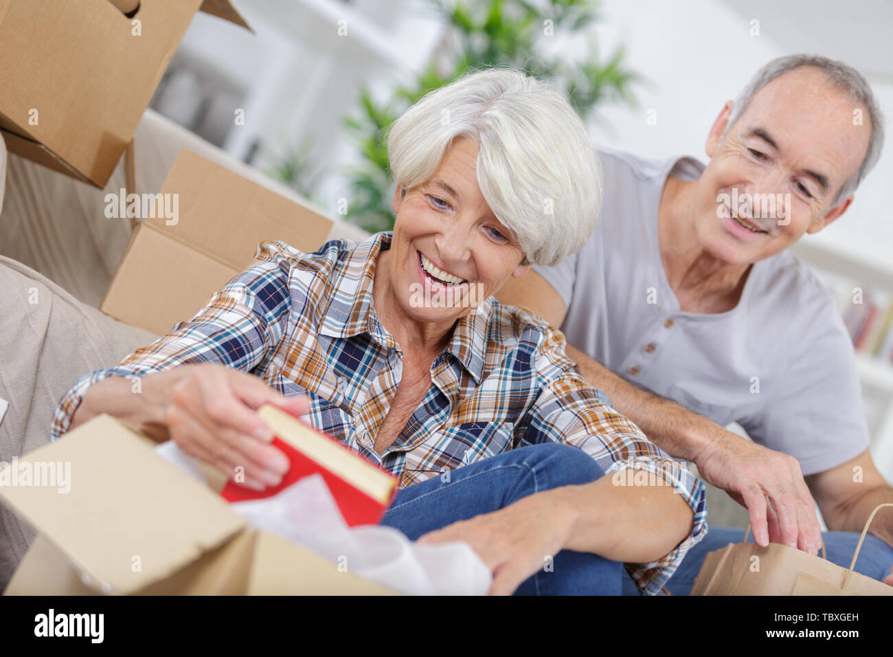 senior couple happy opening a box Stock Photo - Alamy