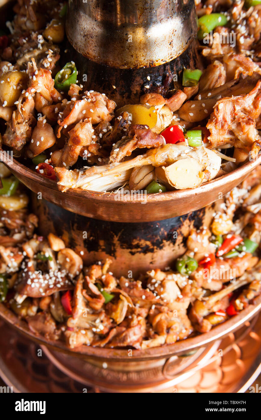 Charcoal fire frog pot field chicken meal Stock Photo - Alamy