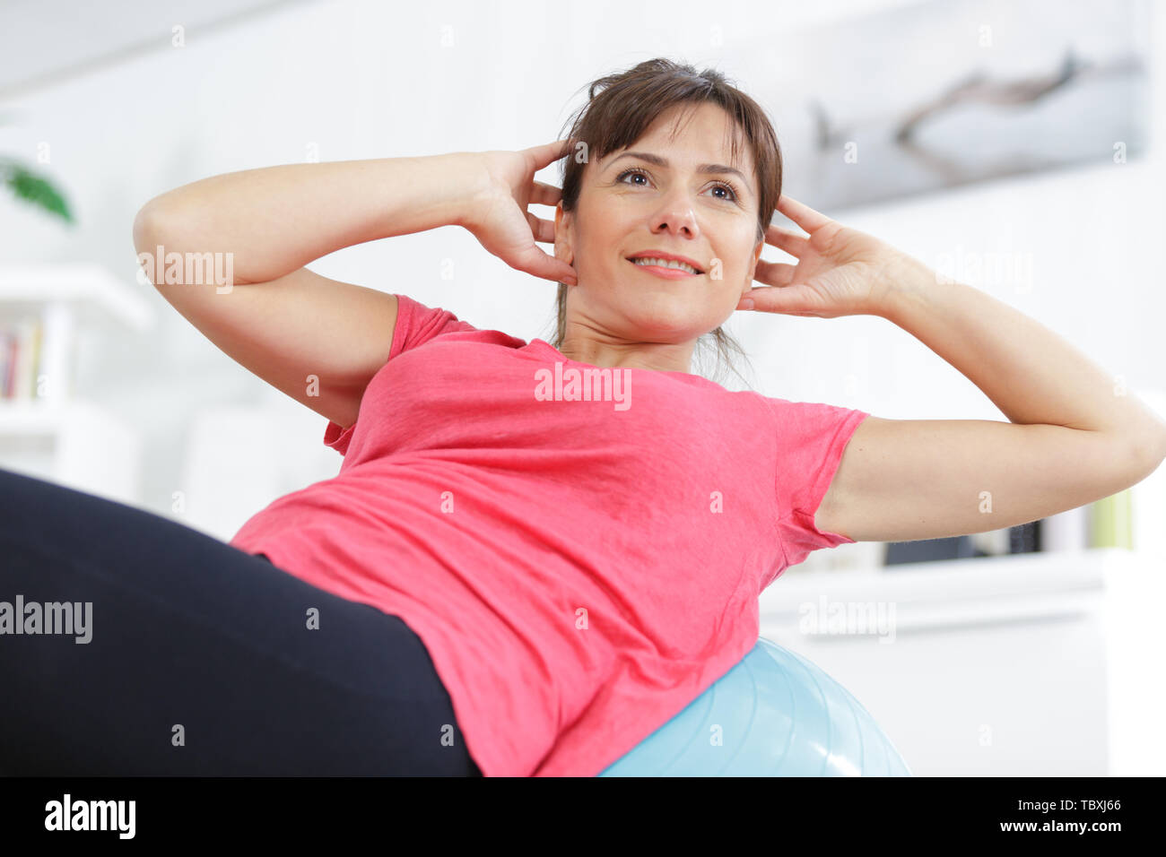 Woman exercise home crunches hi-res stock photography and images - Alamy
