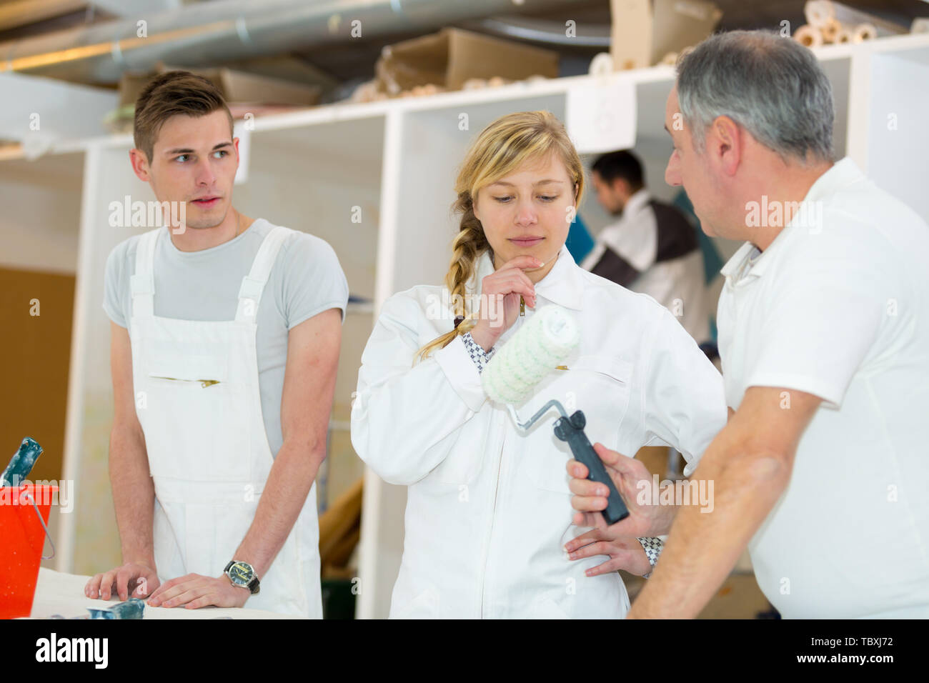 teaching painter apprentice at work Stock Photo - Alamy