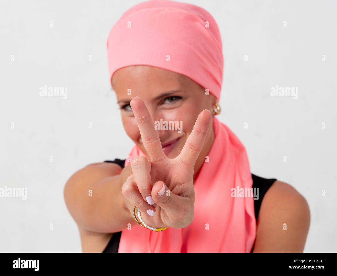 Young girl with pink handkerchief on her head and white background ...