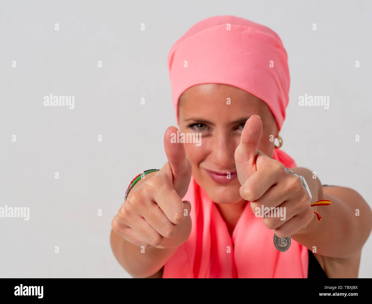 Young girl with pink handkerchief on her head and white background ...