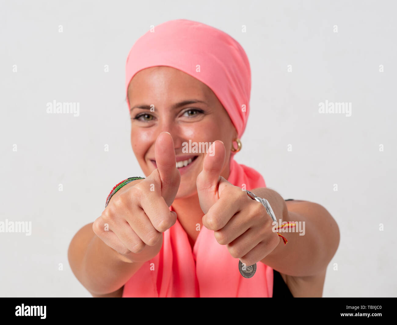 Young girl with pink handkerchief on her head and white background ...