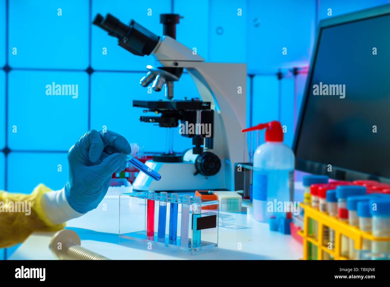 Scientific experiment in microbiological lab. Microscope and test tube ...