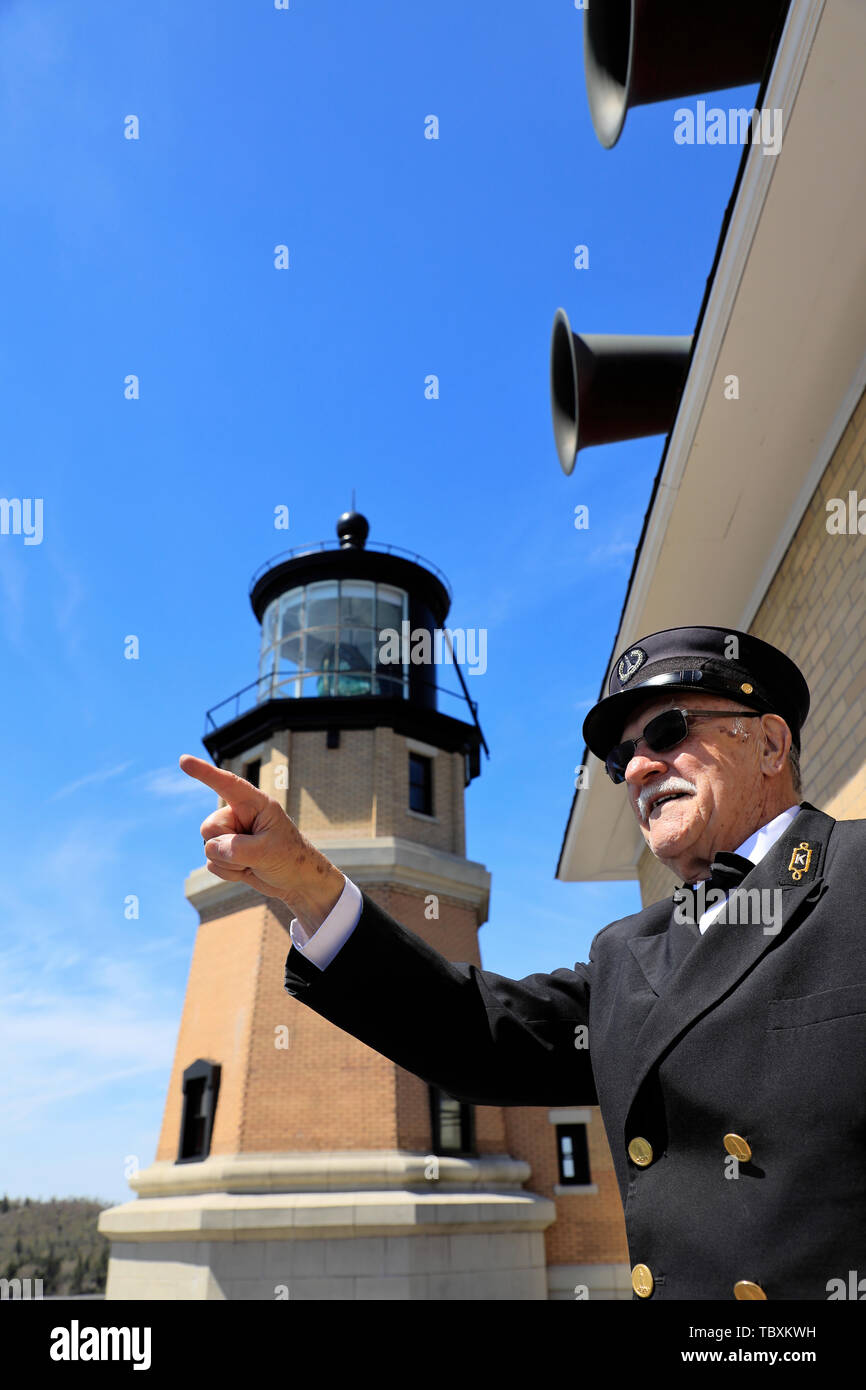 A male guide in traditional lighthouse keepers' uniform posing by the ...