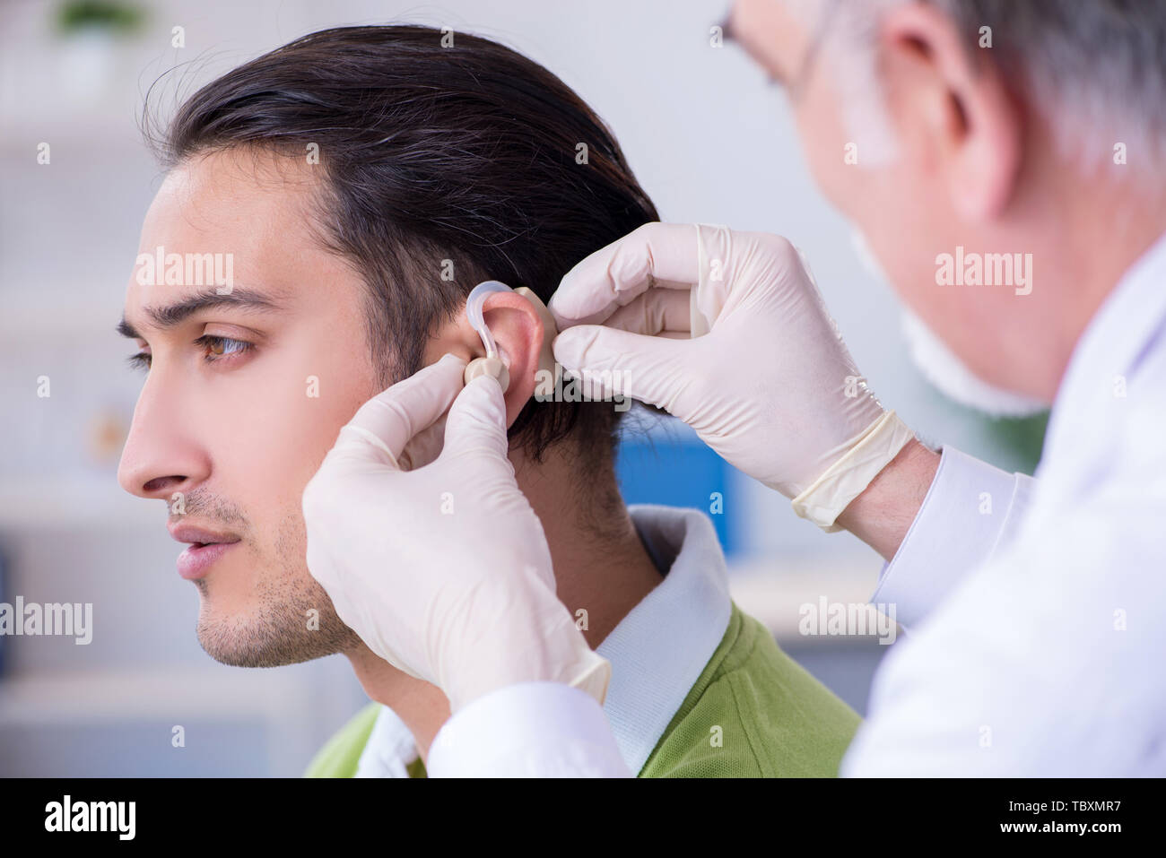 Male patient with hearing problem visiting doctor otorhinolaryngologist ...