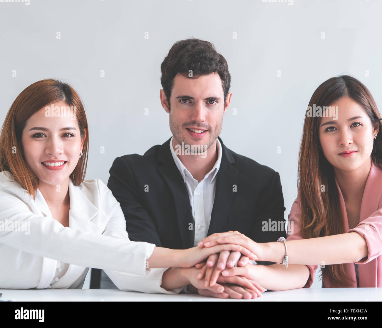 Three people hand together in business meeting for team concept Stock ...