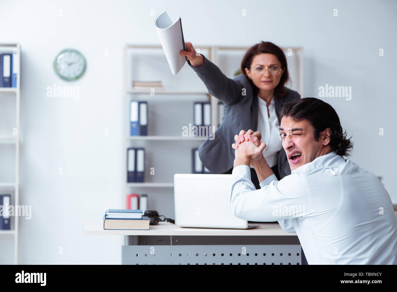 Old female boss and young male employee in the off hi-res stock ...