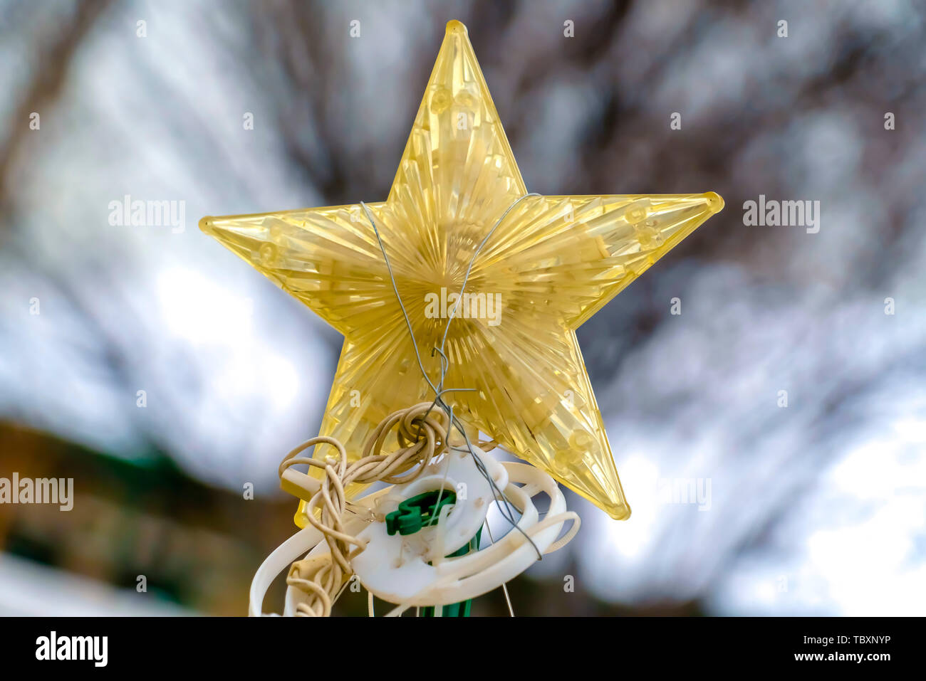 Yellow star Christmas decor isolated against a blurry background of ...