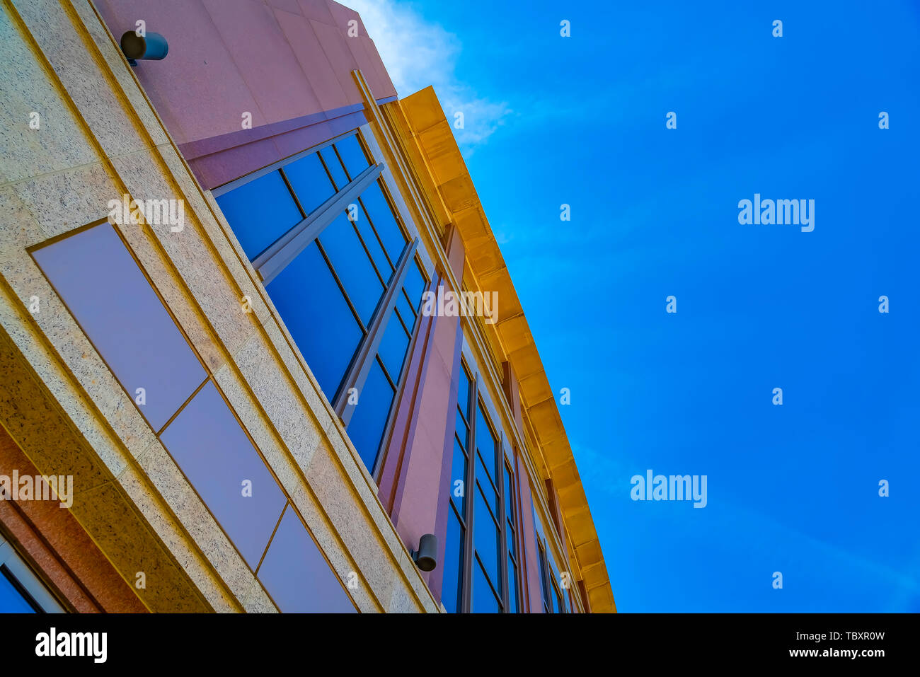 Commercial building exterior with cylindrical wall lights and blue ...