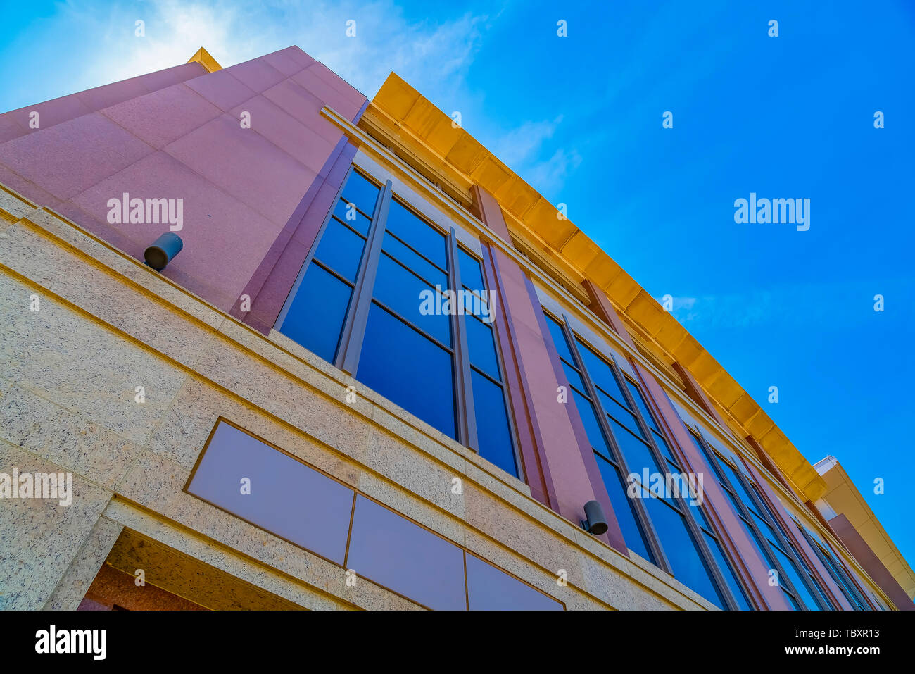 Modern building viewed from below with blue sky background on a sunny ...