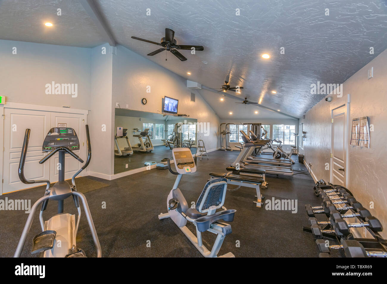 Interior of a spacious fitness gym with various exercise equipment ...