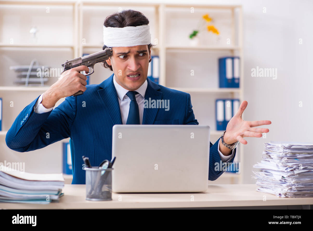 Head injured male employee working in the office Stock Photo - Alamy