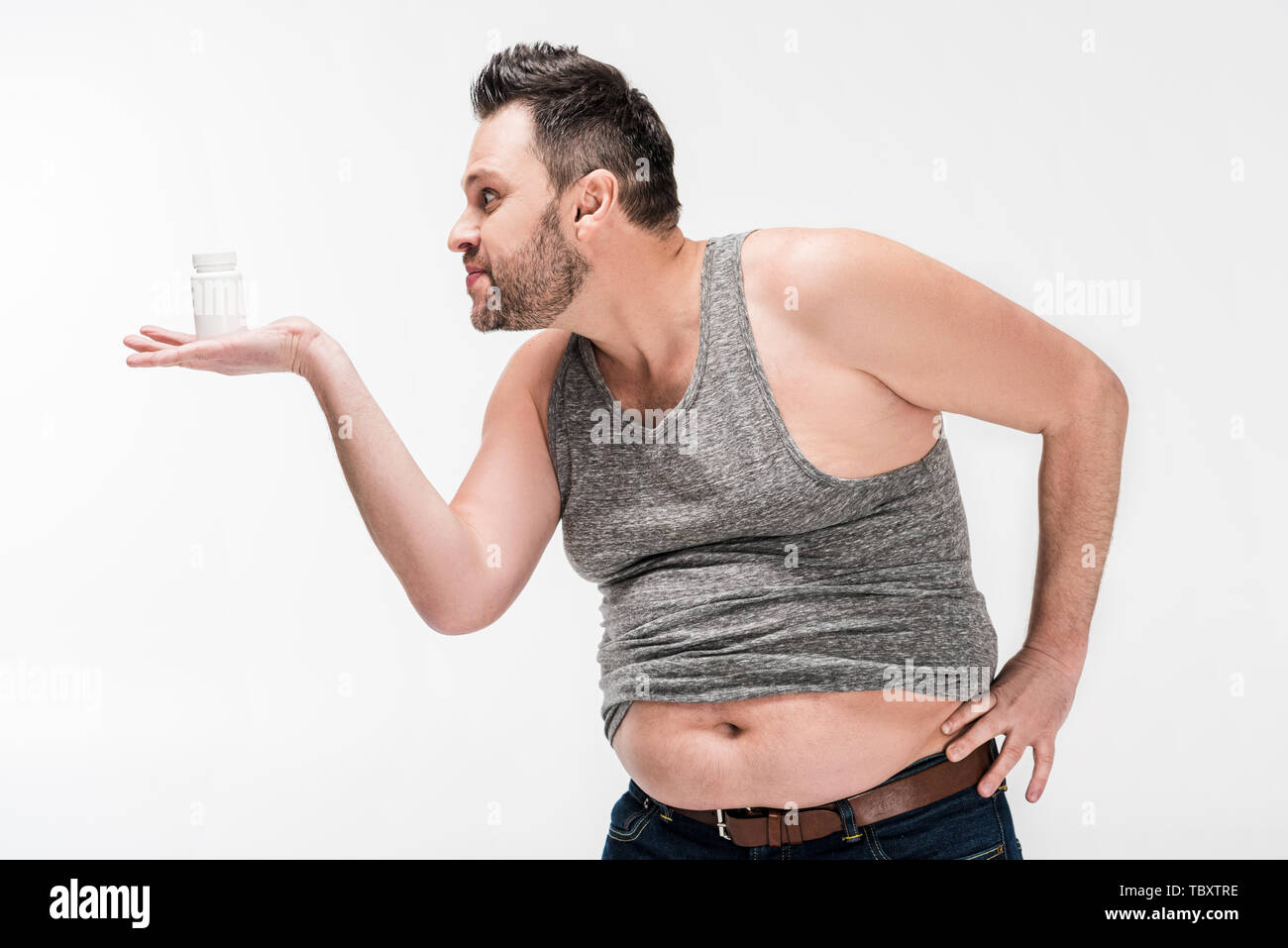 overweight man holding bottle of medicine isolated on white Stock Photo ...