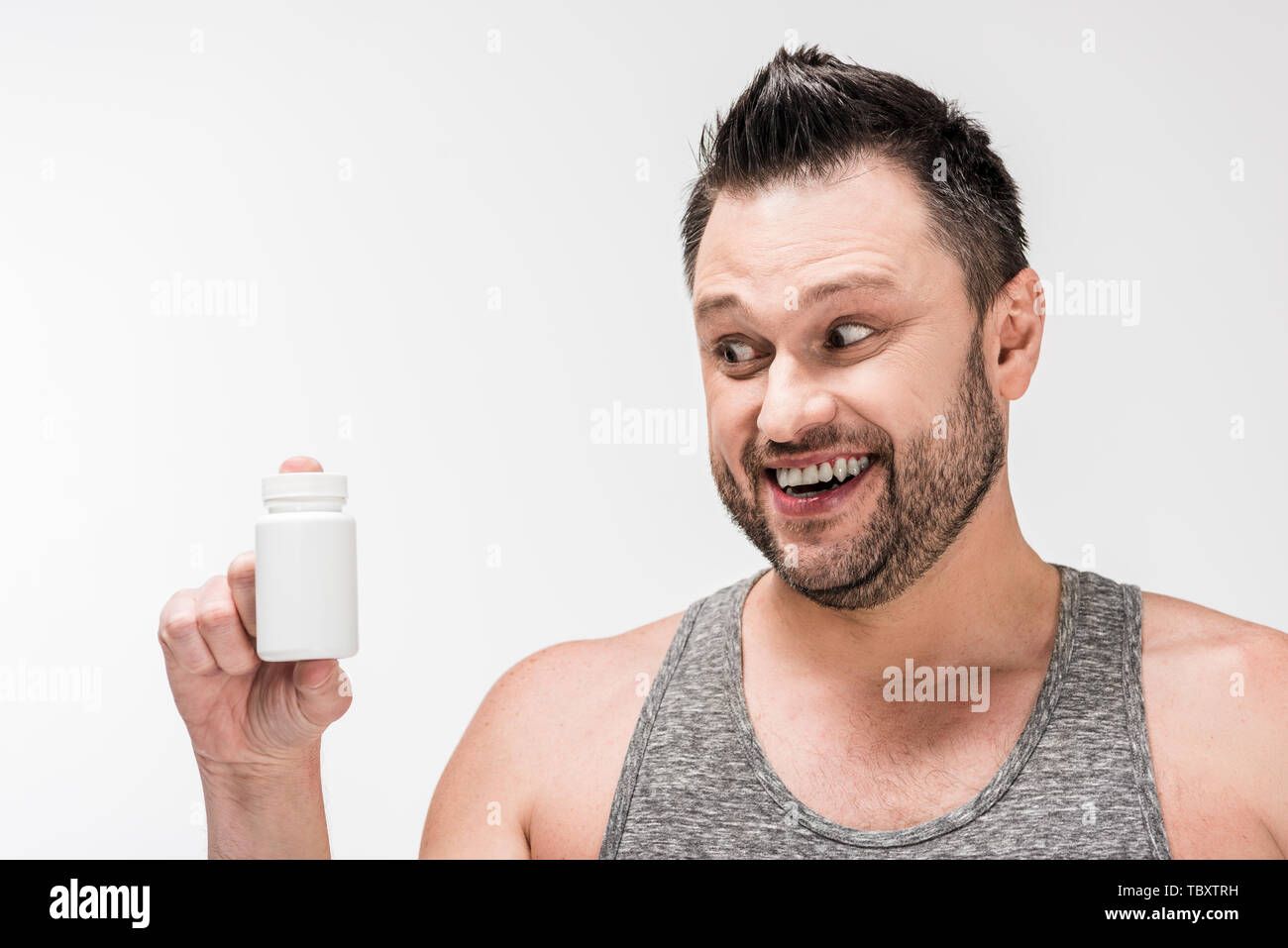 happy overweight man holding bottle of medicine isolated on white Stock ...