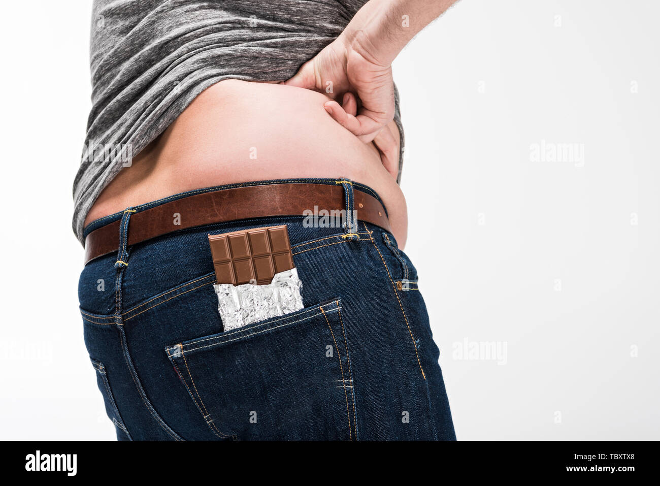 partial view of overweight man with chocolate bar in pocket isolated on ...
