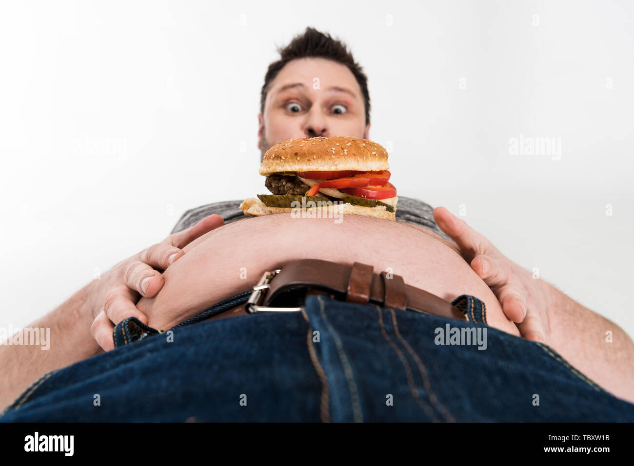 shocked overweight man with burger on belly isolated on white Stock ...