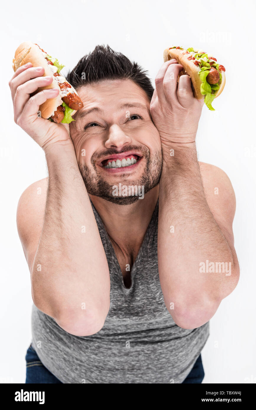 happy overweight man holding hot dogs isolated on white Stock Photo - Alamy