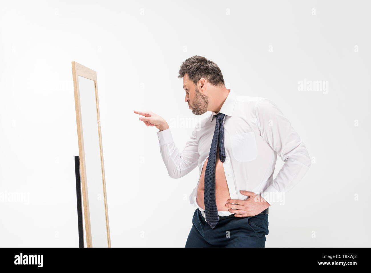 overweight man in formal wear pointing with finger while looking at ...