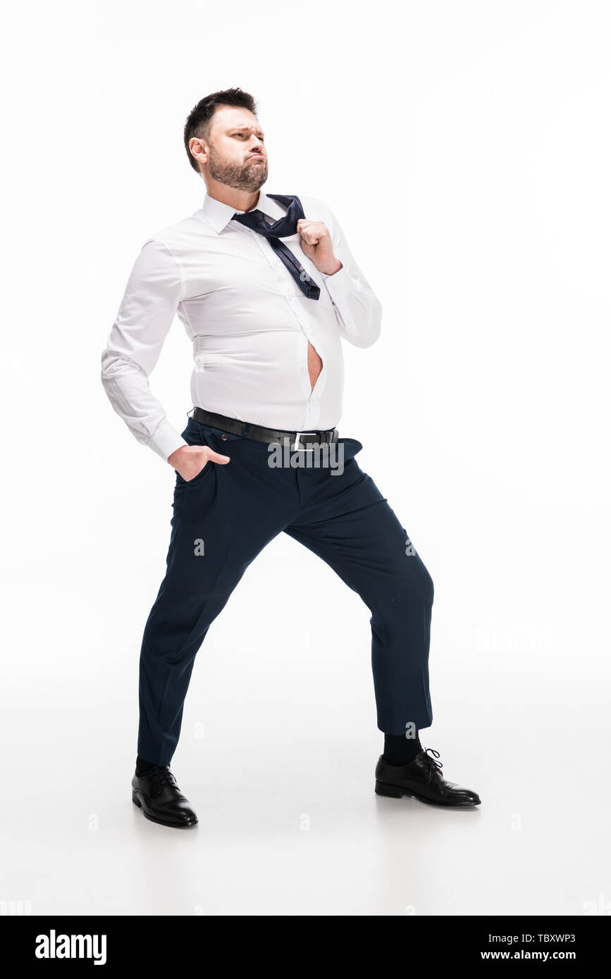 overweight man in tight formal wear with hand in pocket posing on white ...