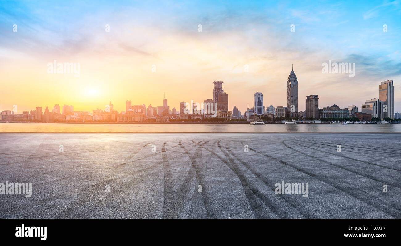 Shanghai bund city skyline and empty asphalt road ground at sunset ...