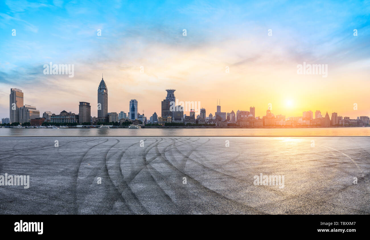 Shanghai bund city skyline and empty asphalt road ground at sunset ...