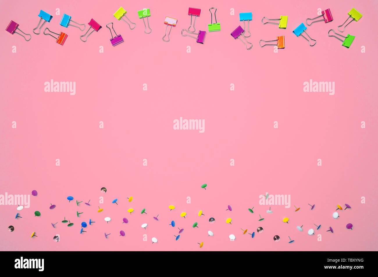 Back to school background with colorful paper clips, knobs pins on ...