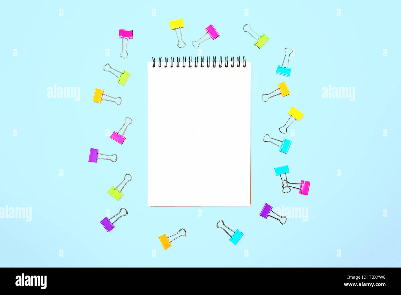 Back to school background with notepad, colorful paper clips on pastel ...
