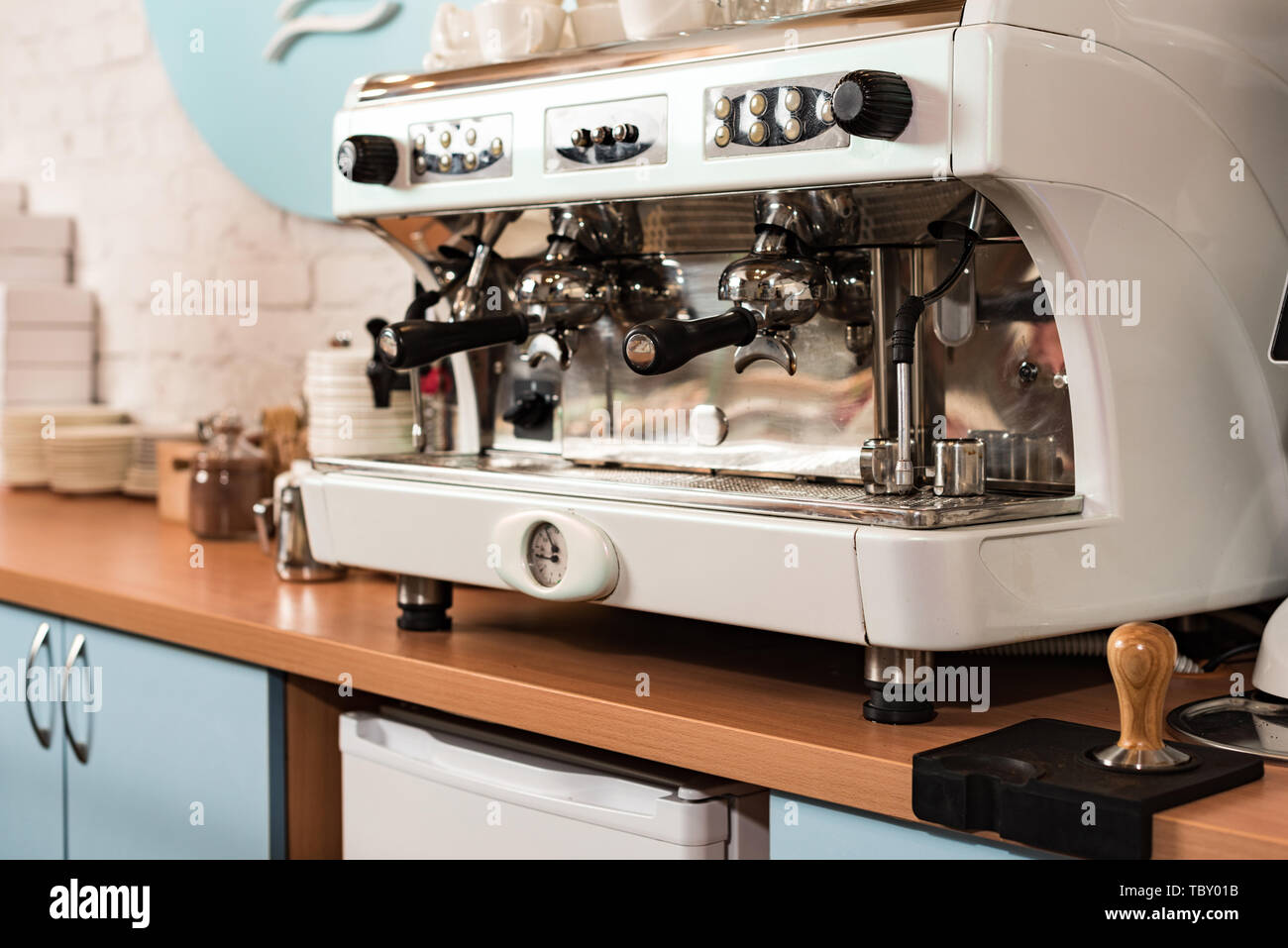 Modern coffee machine on wooden surface in cafe Stock Photo - Alamy