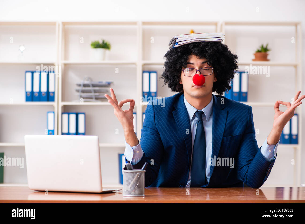 Young clown businessman working in the office Stock Photo - Alamy