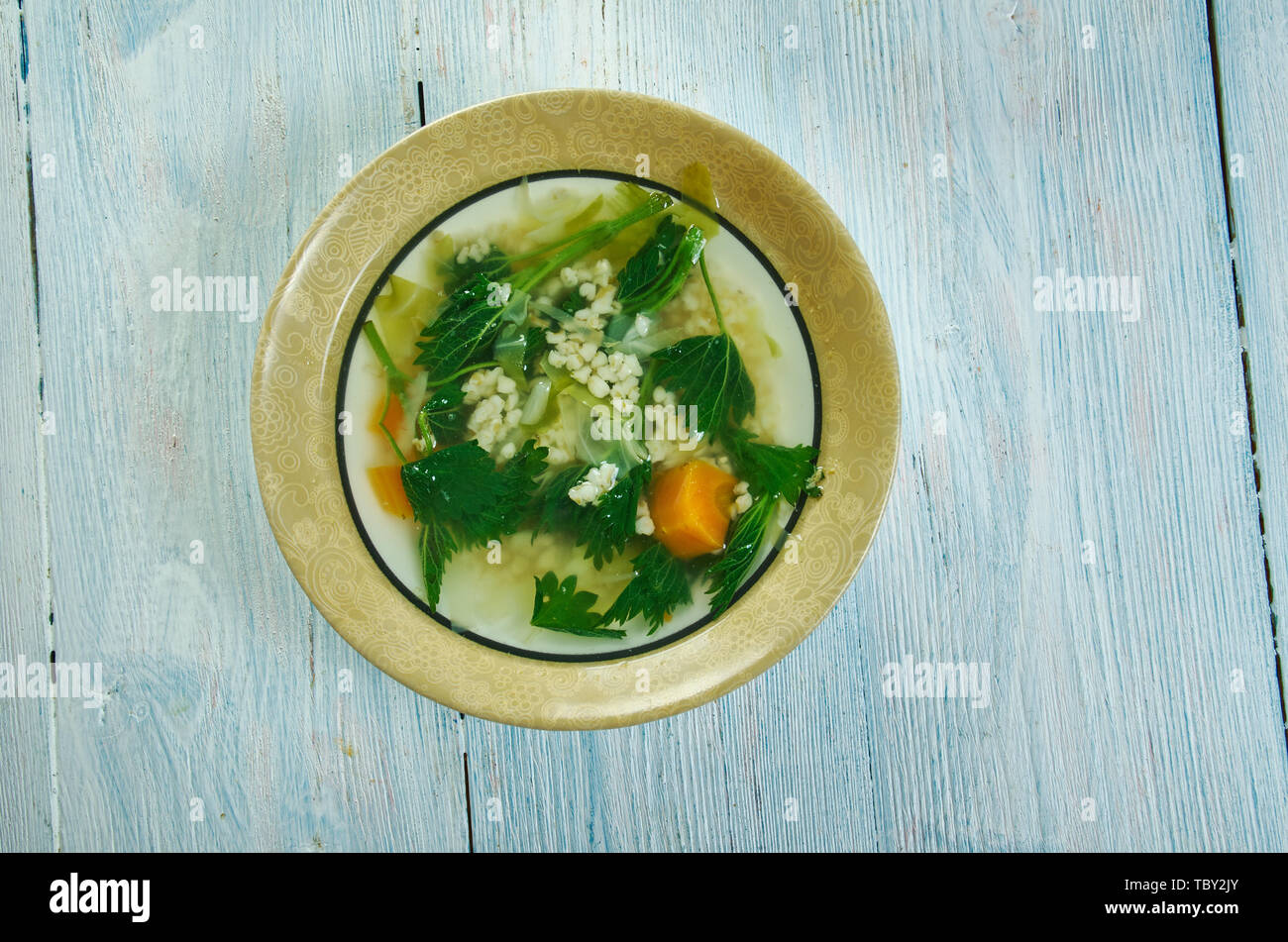 Spring vegetable soup nettle with Wheat Groats close up Stock Photo - Alamy