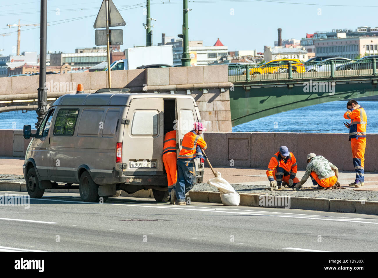 St. Petersburg, Russia, may 30: Five workers in orange overalls ...