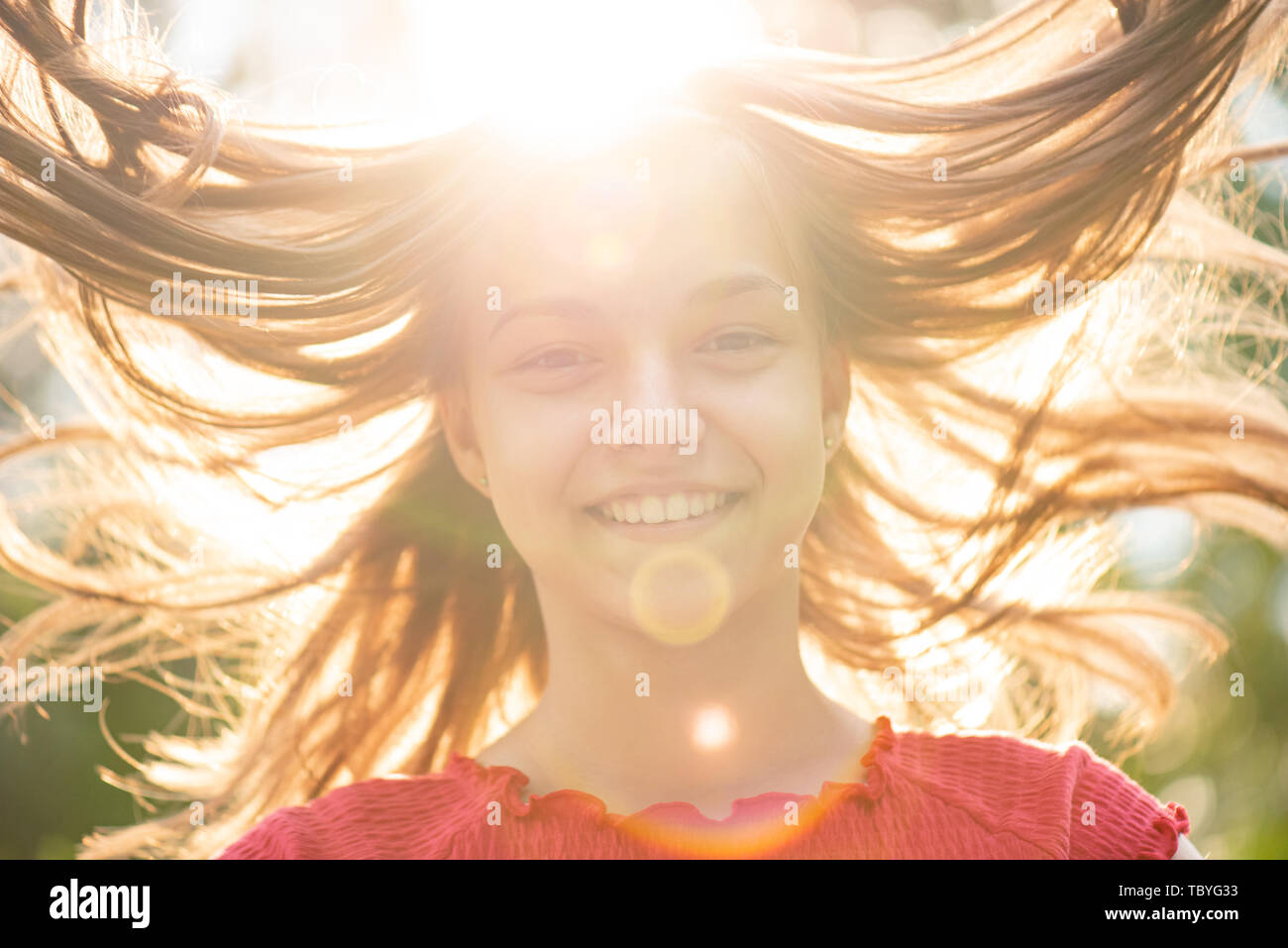 Portrait of teen girl with sun rays Stock Photo - Alamy