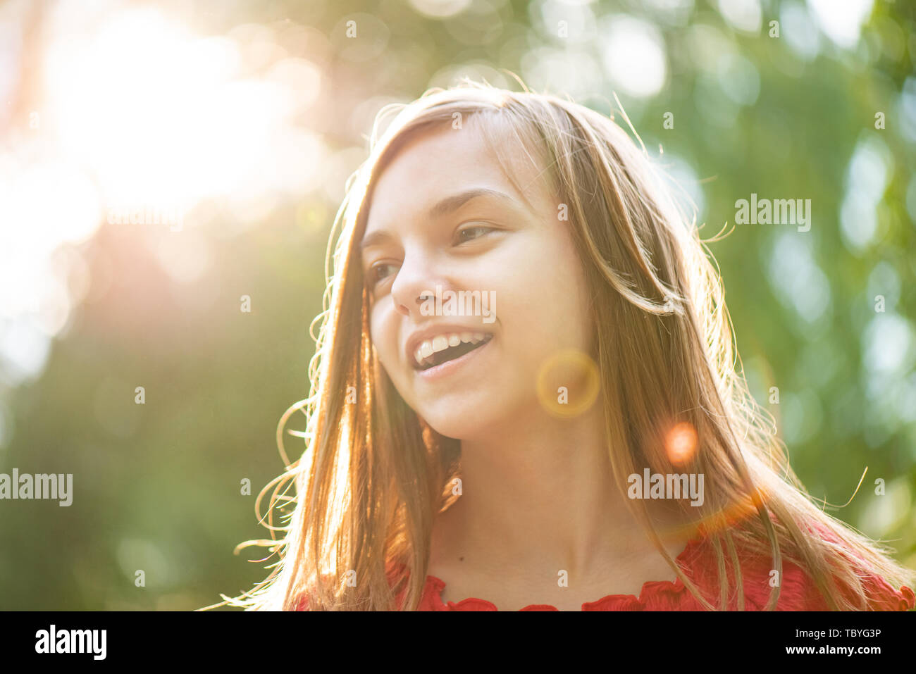 Portrait of teen girl with sun rays Stock Photo - Alamy