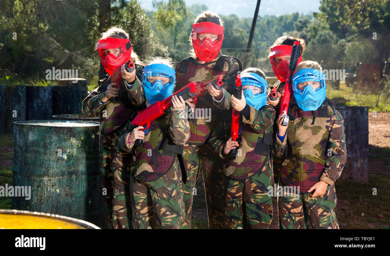 Friendly cheerful positive smiling group of children paintball players ...