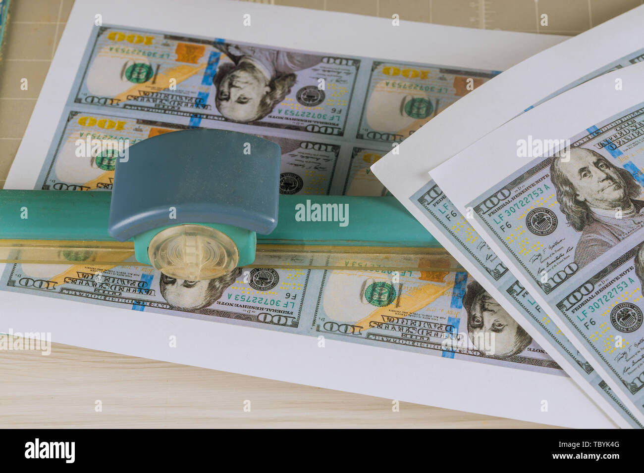 Fake money currency counterfeiting cutting fake US dollars cutter ...