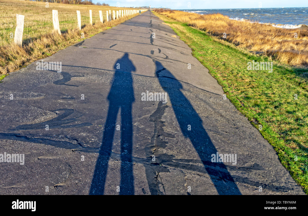 Shadow of two people on the ground Stock Photo - Alamy