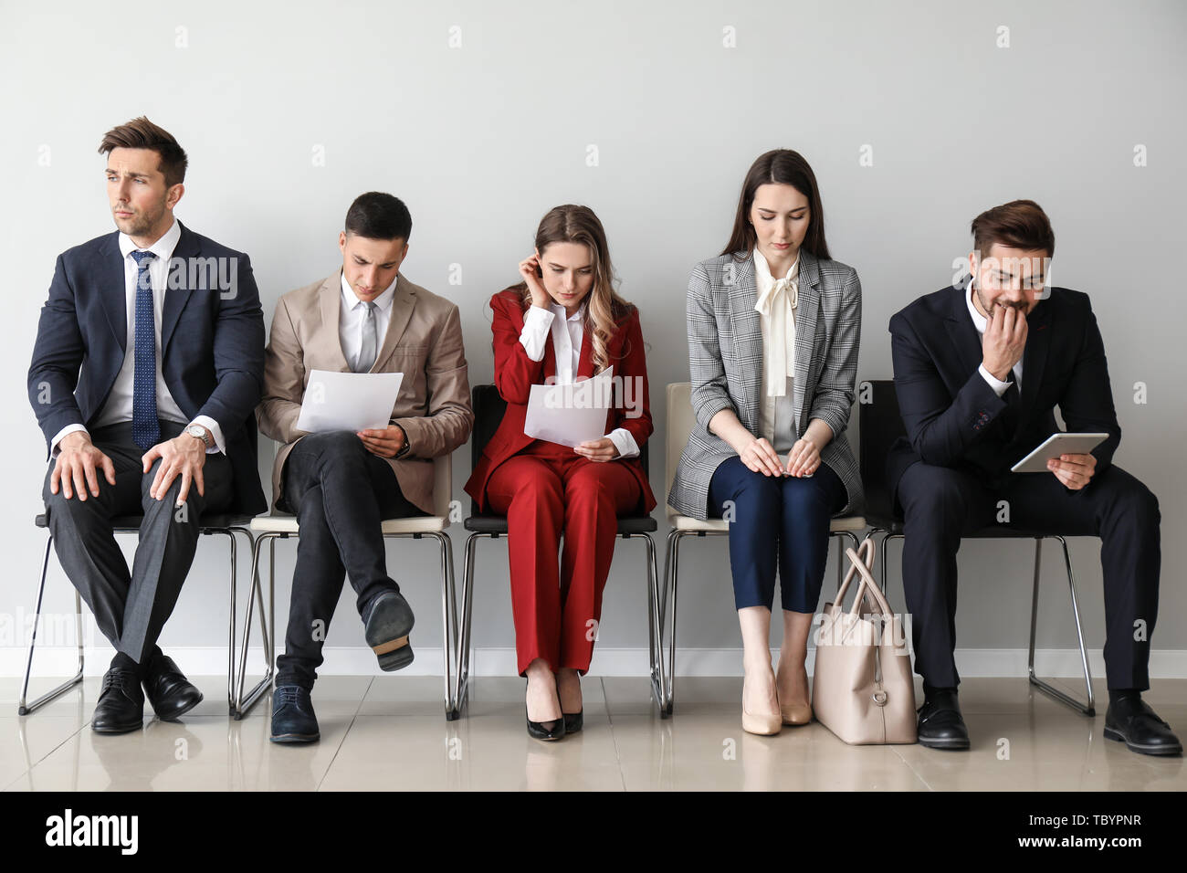 Young people waiting for job interview indoors Stock Photo - Alamy