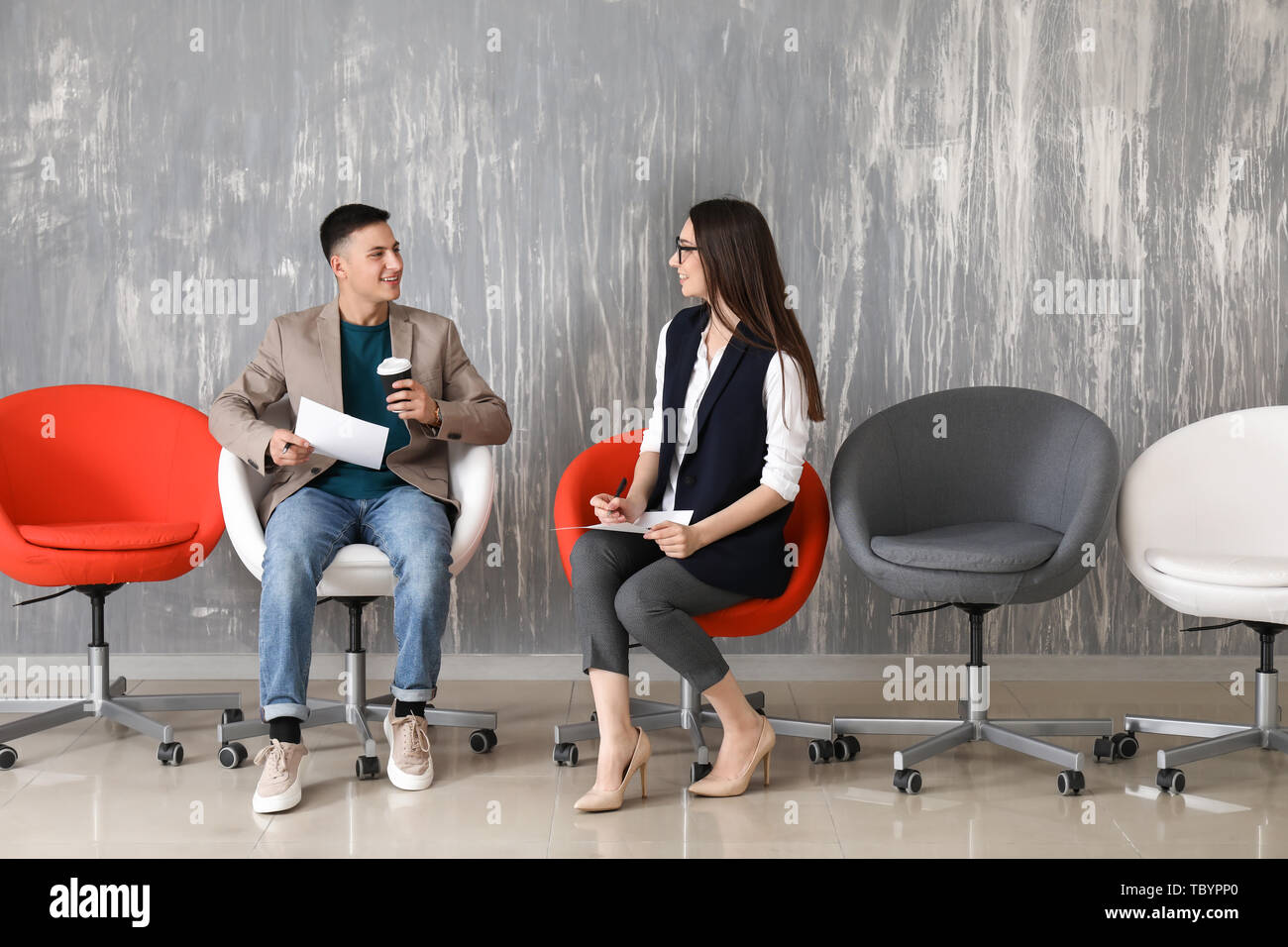 Young people waiting for job interview indoors Stock Photo - Alamy