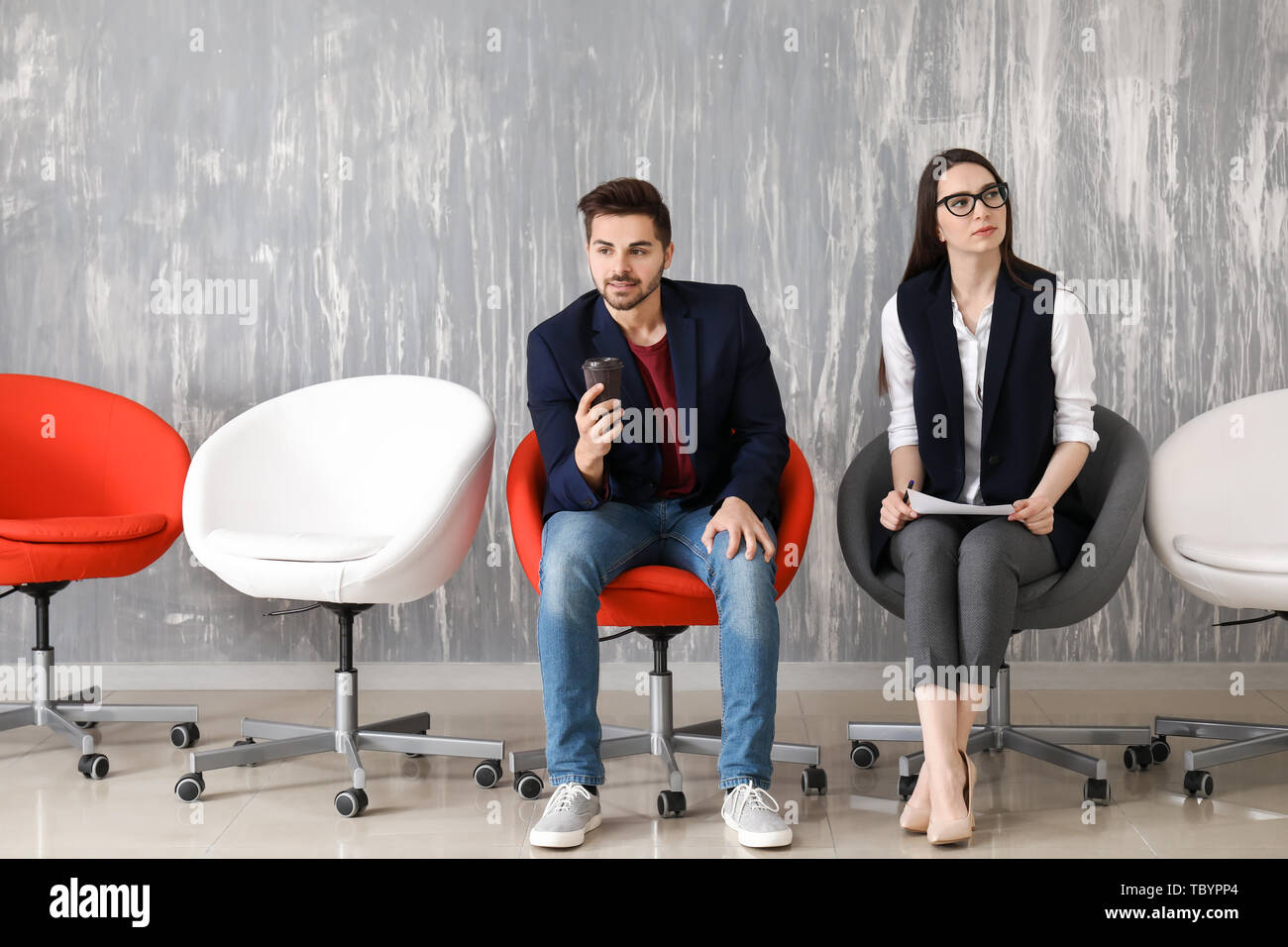 Young people waiting for job interview indoors Stock Photo - Alamy