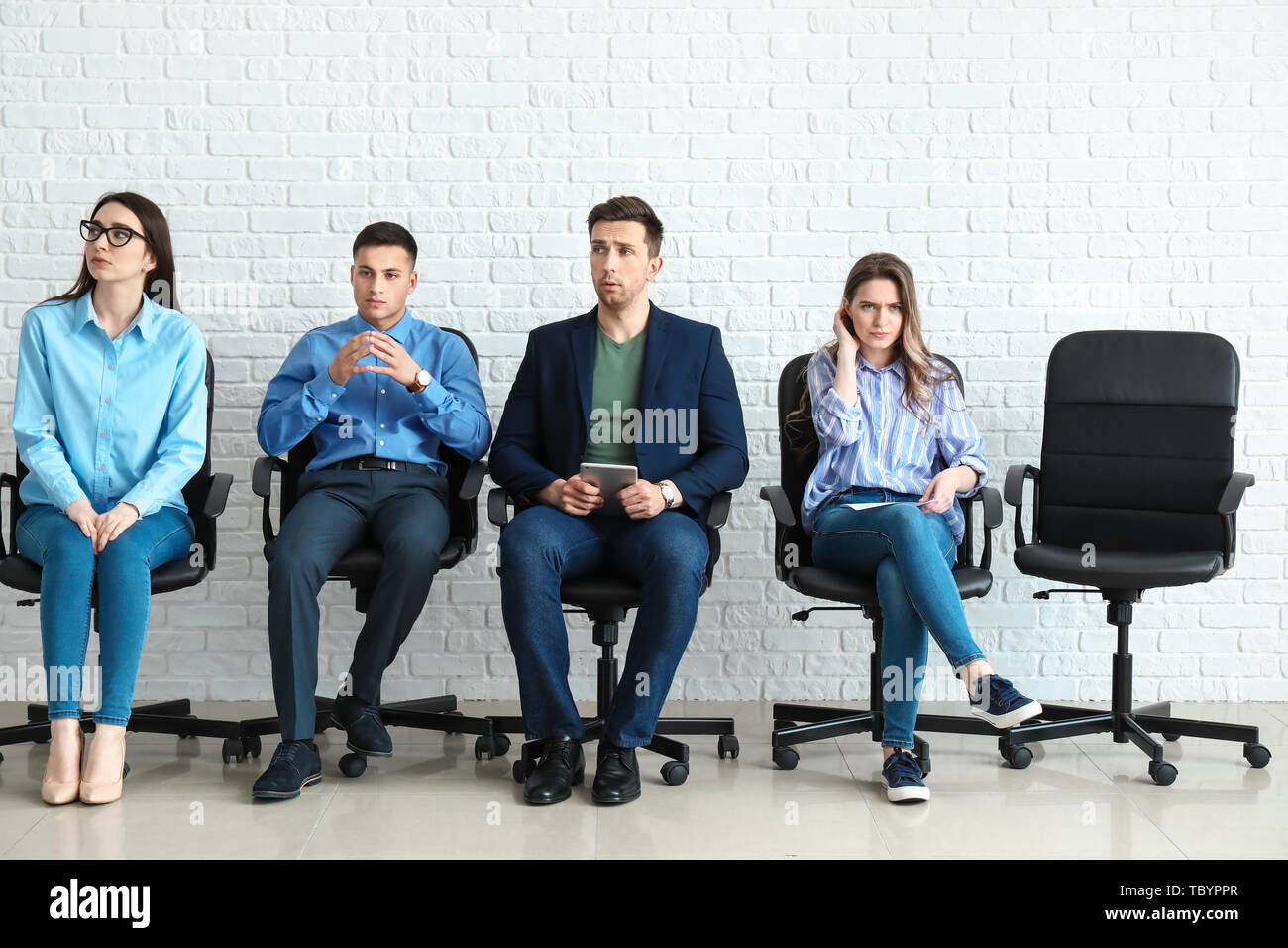 Young people waiting for job interview indoors Stock Photo - Alamy